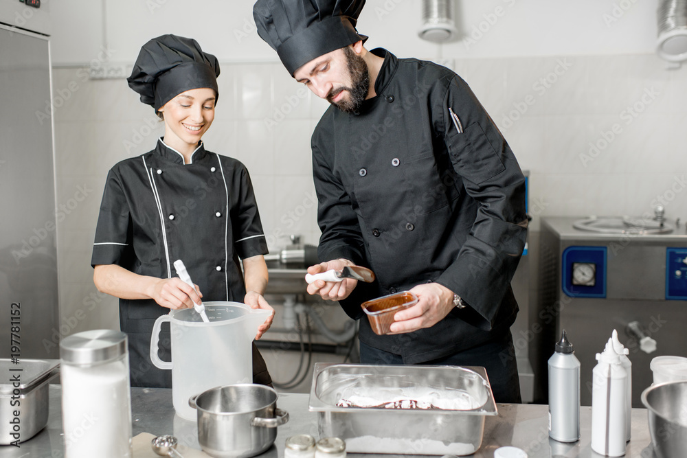 Chef cook pouring chocolate during the ice cream production process ...