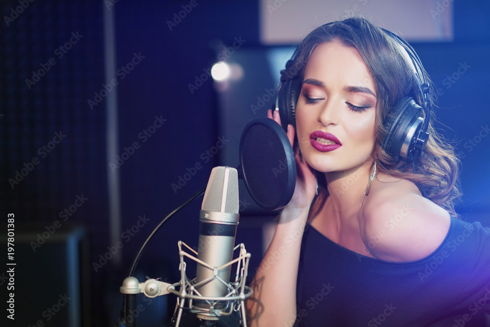 Beautiful young singer who recorded a song in a professional recording ...