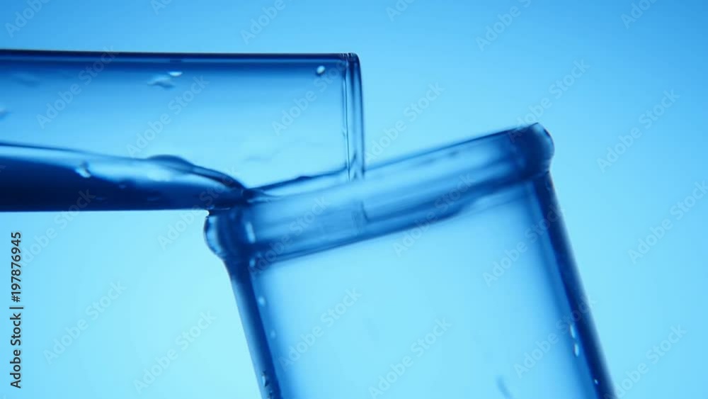 A macro shot of two sample tubes touching each other cautiously. Clean ...