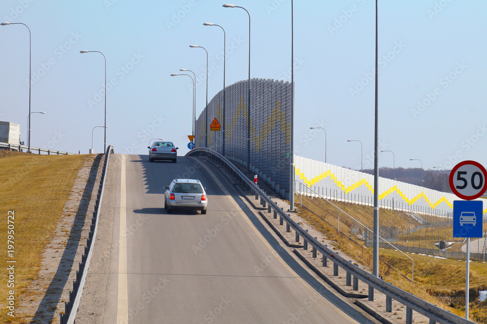 A noise-absorbing barrier also called a soundwall, noise wall, sound ...