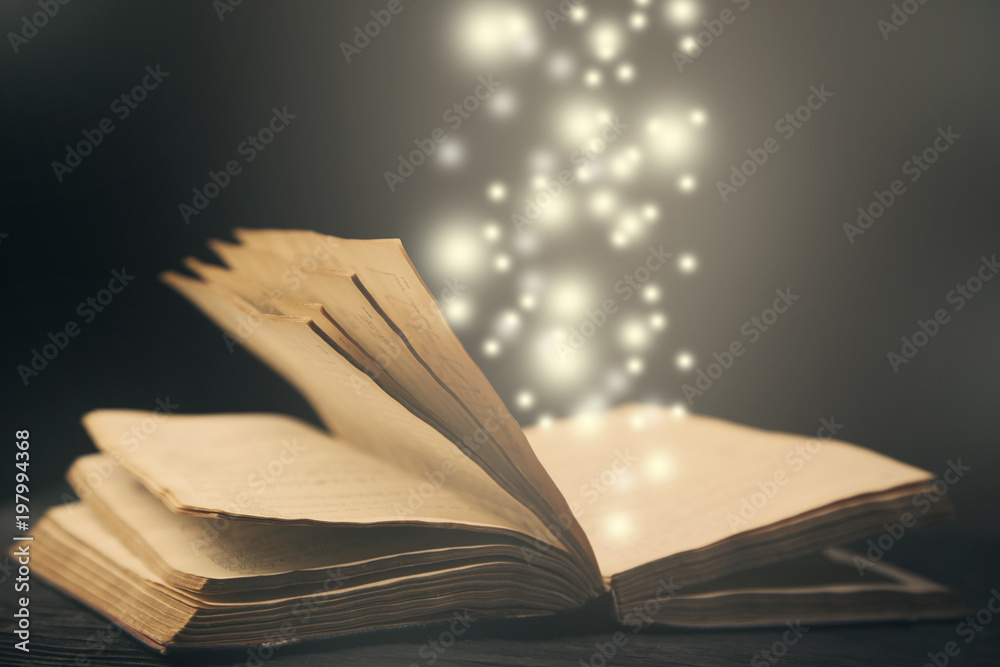 old book open light effect moving up particles photo Stock Photo ...
