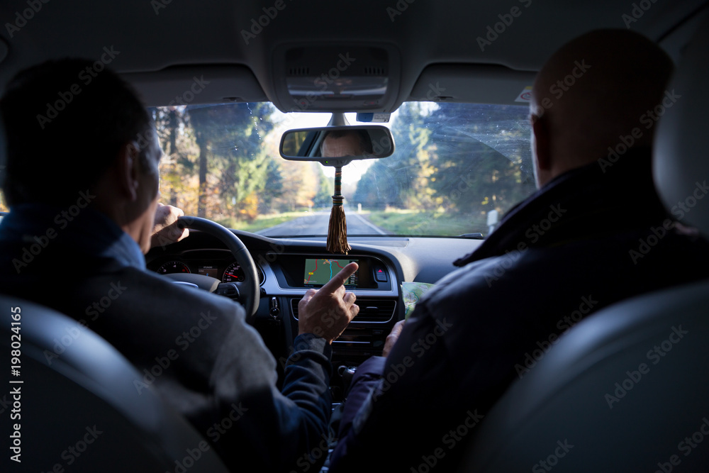 Inside view of senior men driving car on forest road trip Stock Photo ...
