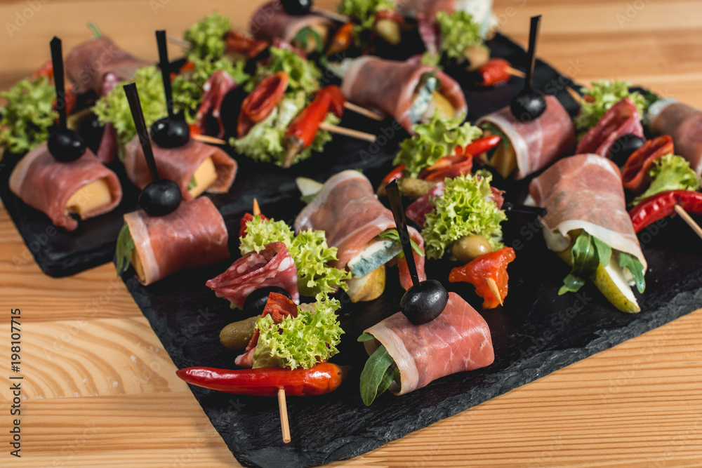 spanish snack, banderillas on skewers with jamon, ramses, pear, dorblue ...