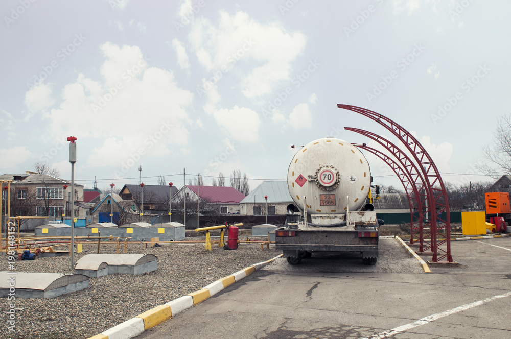 Fuel Tanker Truck at the Gas Station. The worker prepares the device ...