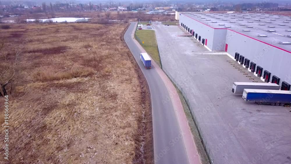 Buildings of logistics center, warehouses in the field near the highway ...