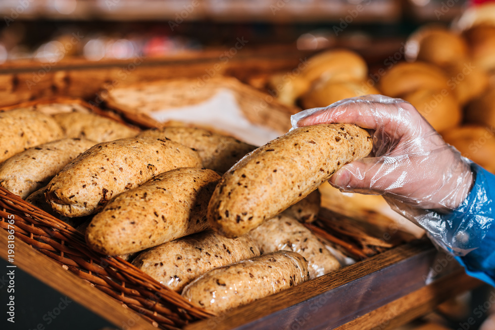 partial view of shopper taking loaf of bread in grocery shop Stock ...