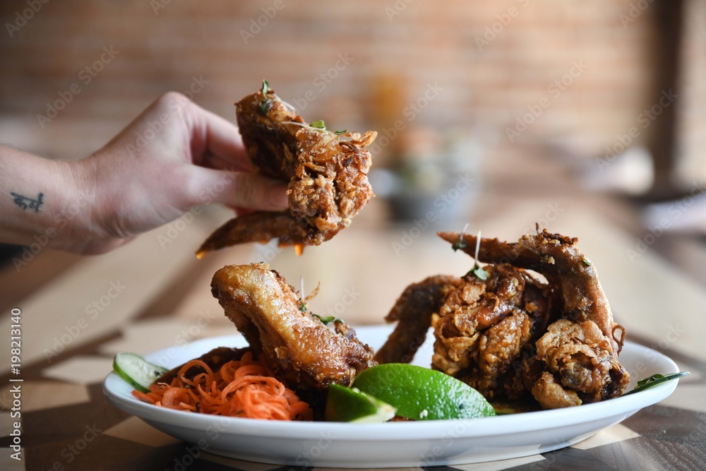 Hand holding fried chicken Stock Photo | Adobe Stock
