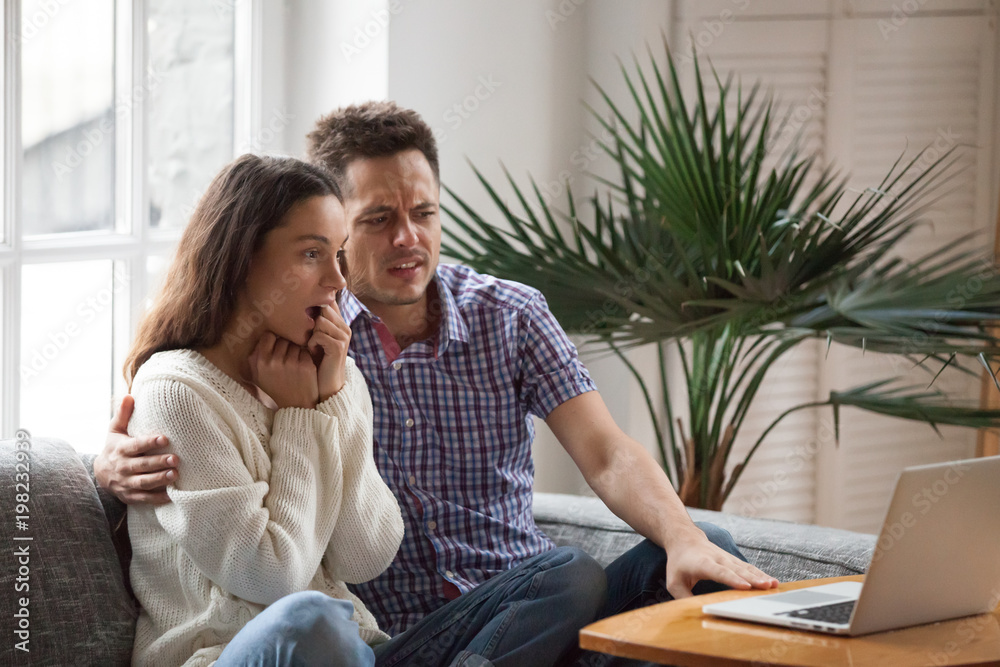 Scared Man Embracing Shocked Woman Watching Thrilling Horror Film Or