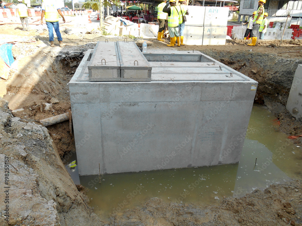 Precast concrete manhole for underground utility services under ...
