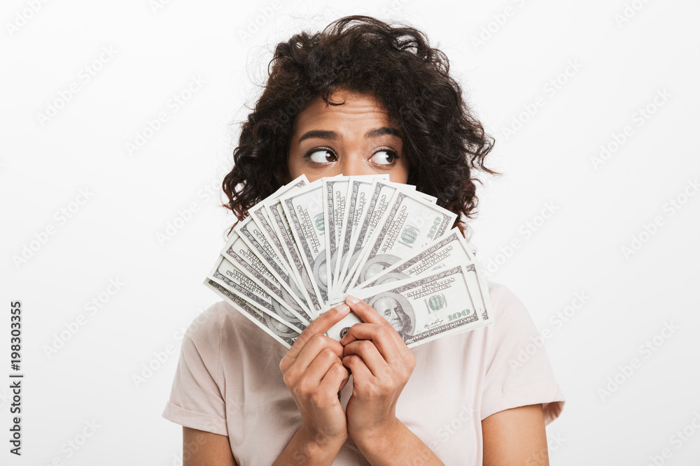 Beautiful american woman with afro hairstyle covering face with fan of ...