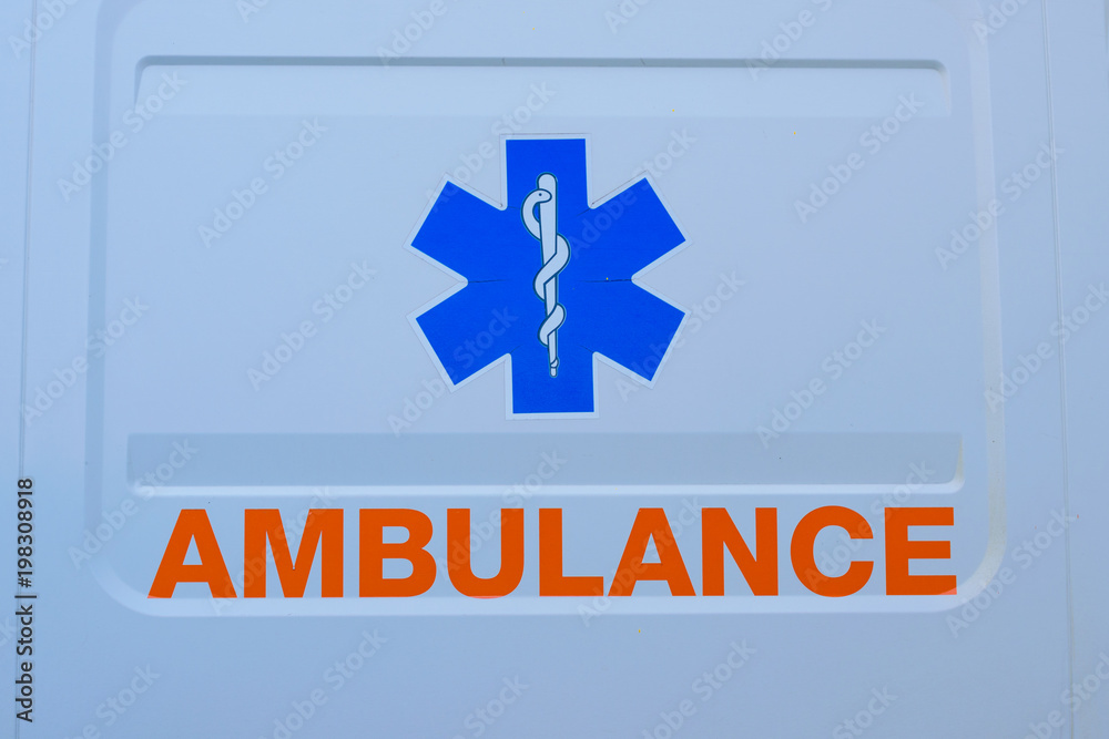 Photograph of ambulance car sign and text on white. The emergency ...