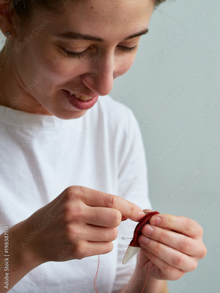 Step-by-step process of manual manufacturing baby crib mobile. Sewing a ...