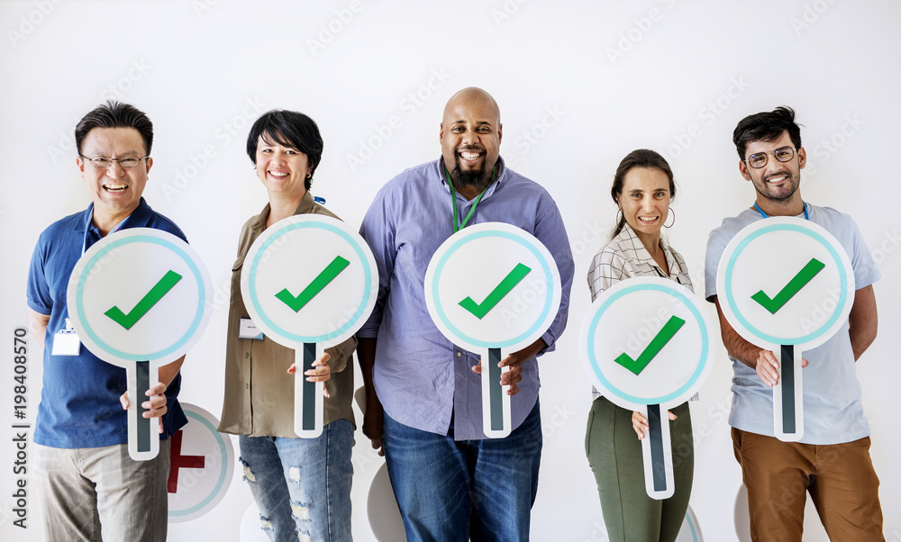 Workers standing and holding correct ticks logos Stock Photo | Adobe Stock