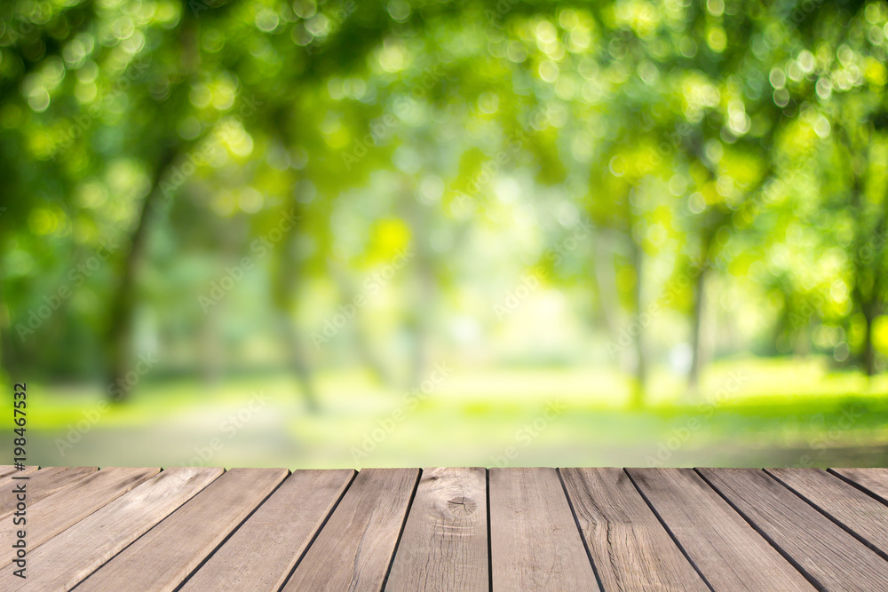 Wooden table with blurred of green natural tree in park background ...