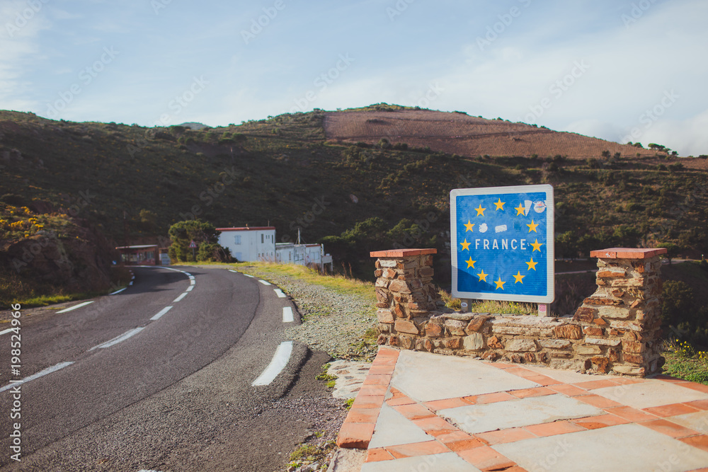French border road sign with European Union blue flag and yellow stars ...