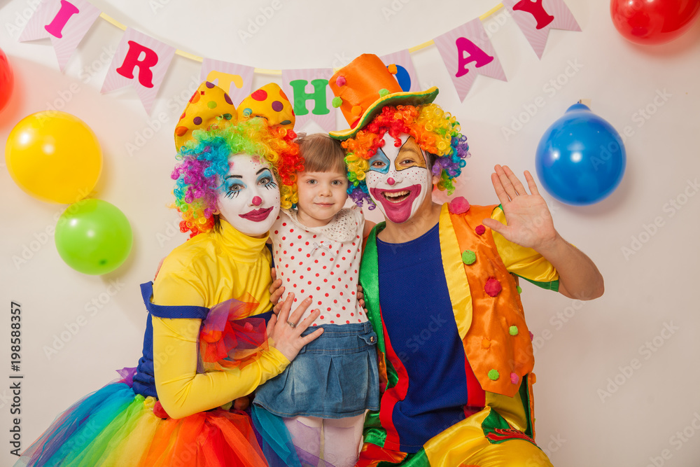 clown boy and clown girl on birthday girl. Party for children. Clowns ...