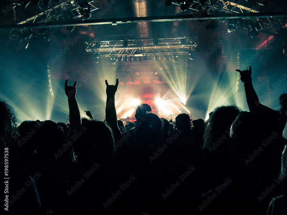 Concert venue with lit stage and fans in front of it Stock Photo ...