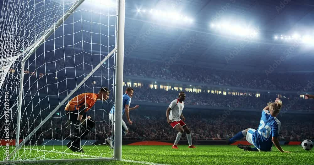 Soccer player scores a goal and runs happily with the ball. Stadium and ...