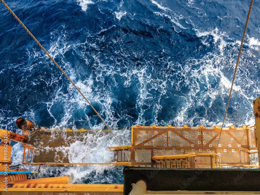 Offshore oil and gas platform at boat landing while the high wave in ...