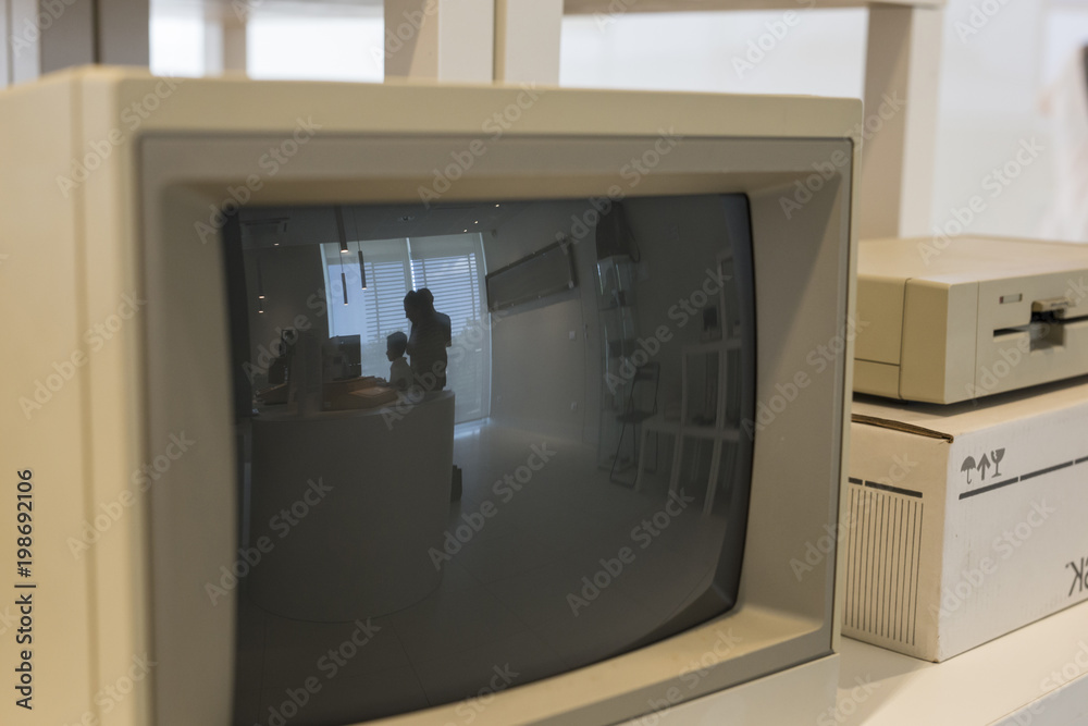 reflected in old monitor screen of people using a computer Stock Photo ...