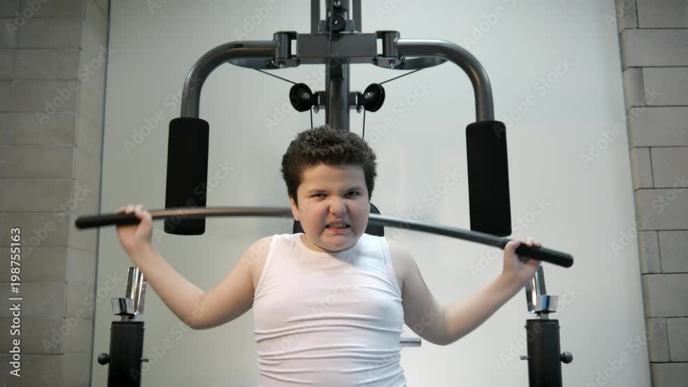 thick angry kid boy trains in gym fat burning.will power children ...