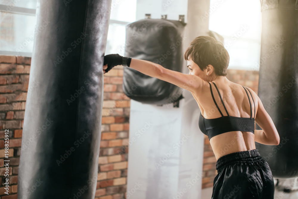 back view photo of ambitious woman taking regular boxing exercises ...