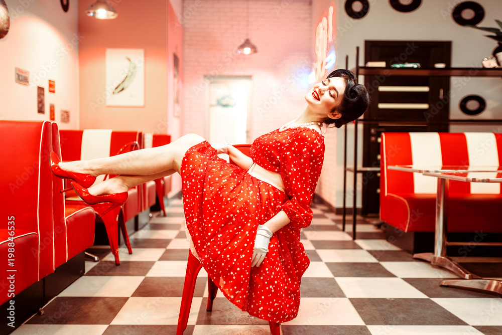 Sexy pin up girl with makeup posing in retro cafe Stock Photo | Adobe Stock