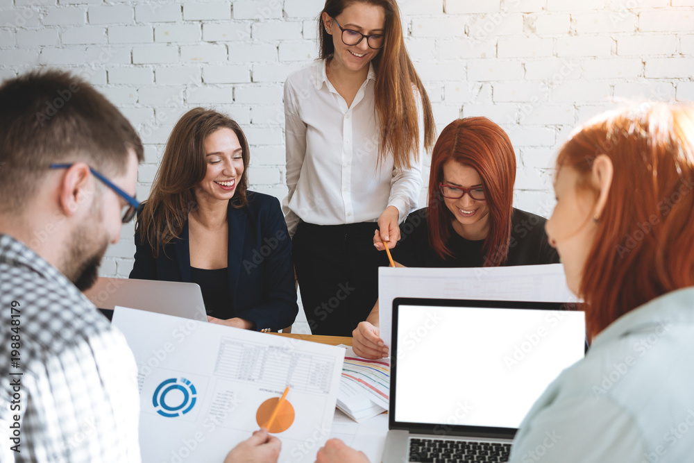 Team of creative managers sitting around table and work with modern ...