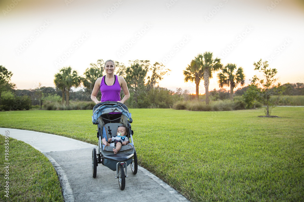Beautiful, fit woman walking and jogging outdoors along a paved ...