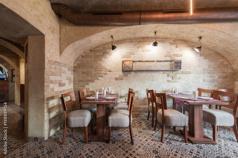 Brick wall and rustic tiled floor in restaurant interior Stock Photo ...