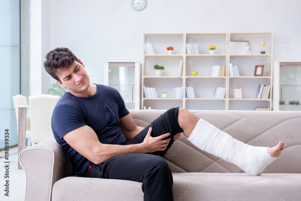 Man with broken leg recovering at home Stock Photo | Adobe Stock