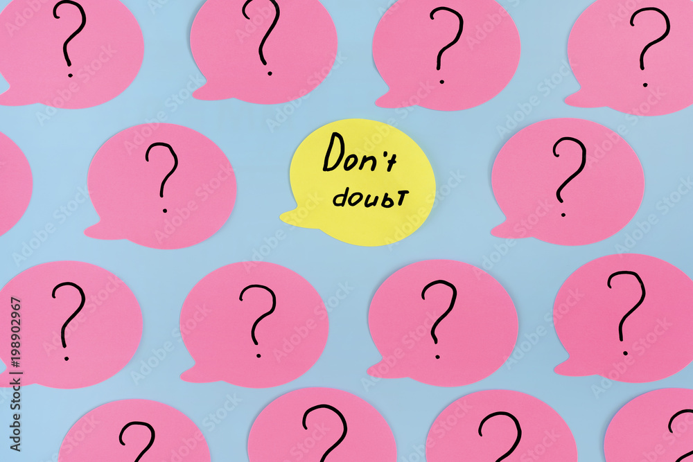 Pink stickers with question marks on a pale blue background. Yellow ...