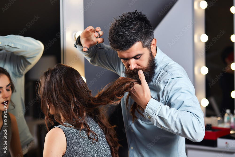 Professional hairdresser working with fashion brunette model with long ...
