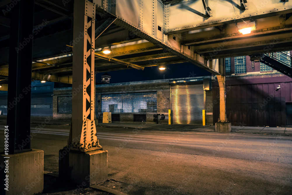 Dark and eerie Chicago urban city street night scenery with elevated ...