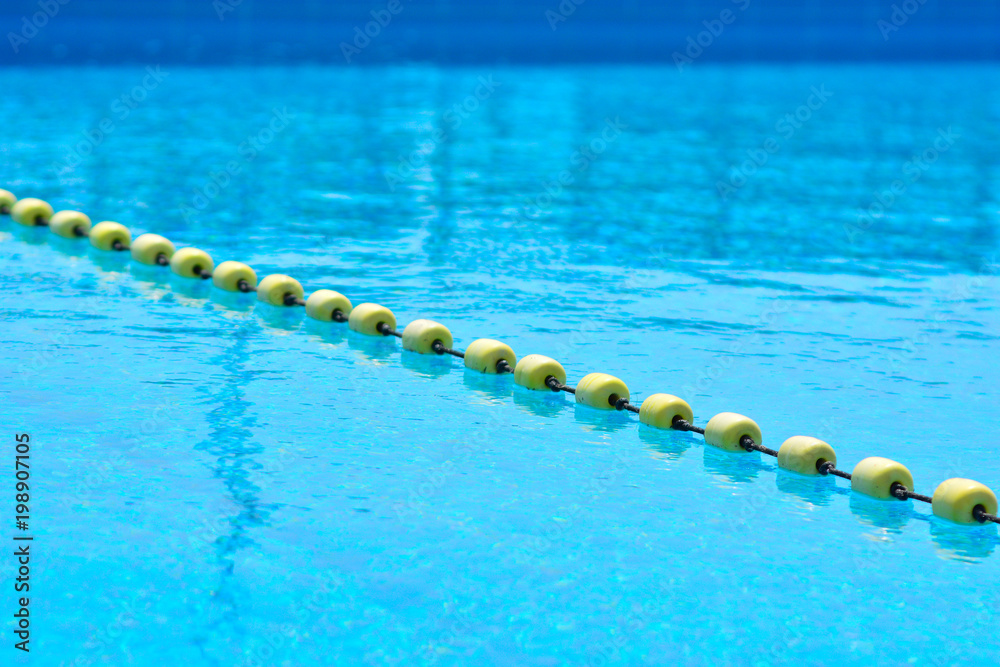 Swimming pool with transparent water, with yellow indicator float line ...