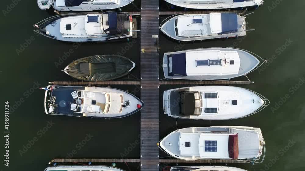 Aerial top down view footage of marina a dock basin with moorings and ...