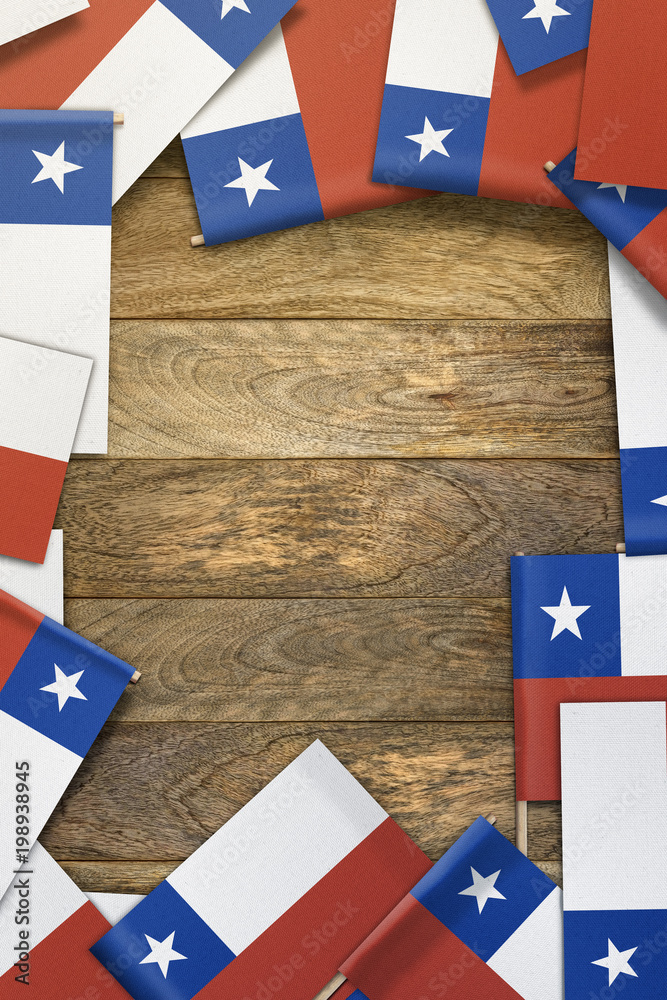 Chile small flags framing a wood texture background with copy space ...