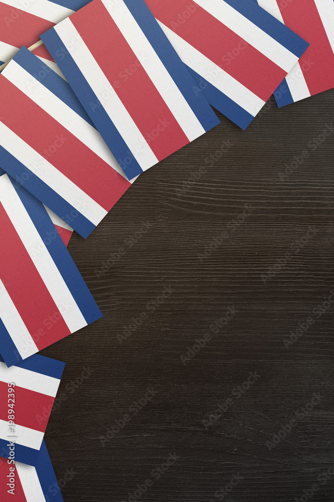 Costa Rica small flags framing a wood texture background with copy ...