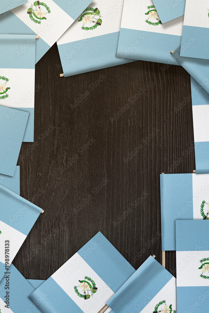 Guatemala small flags framing a wood texture background with copy space ...
