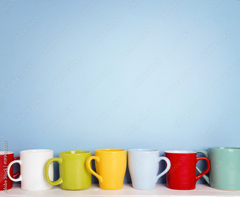 Colorful mugs on a blue background with copy space. Stock Photo | Adobe ...