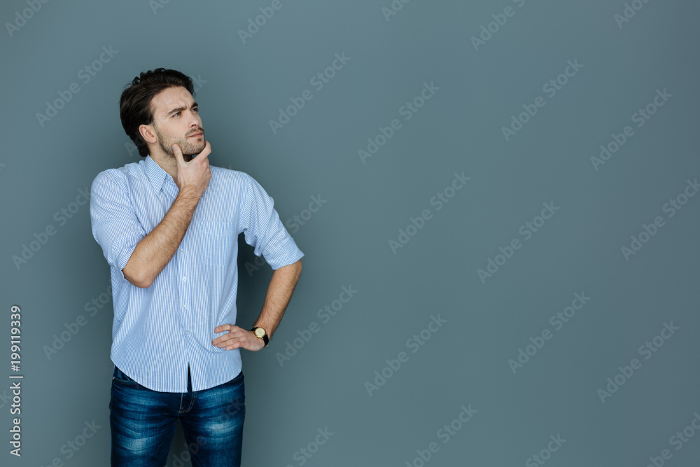 Process of thinking. Nice handsome young man standing against great ...