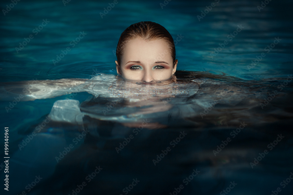 Beautiful model is posing in a swimming pool Stock Photo | Adobe Stock