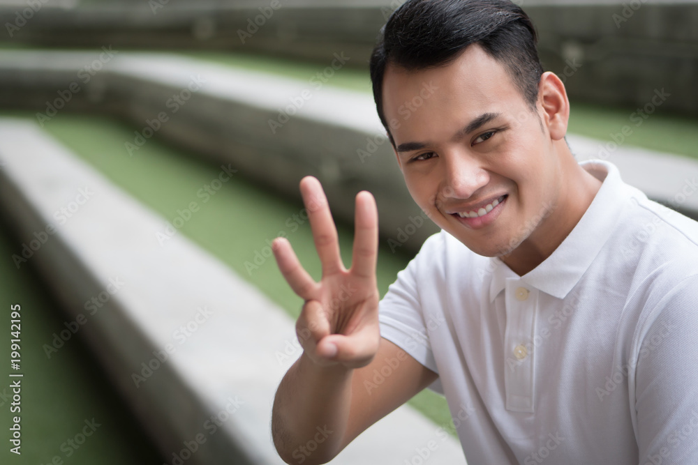 happy man pointing up three finger gesture; smiling friendly man ...