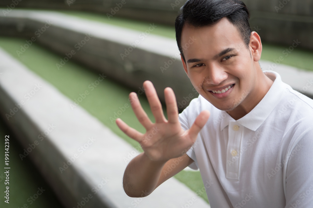 happy man pointing up five finger gesture; smiling friendly man ...