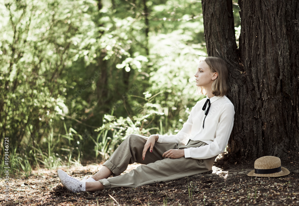 Girl Sitting Against Tree