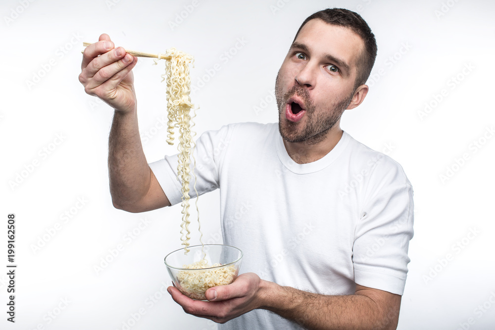 A picture of guy that likes to eat oriental cuisine. He has a plate of ...