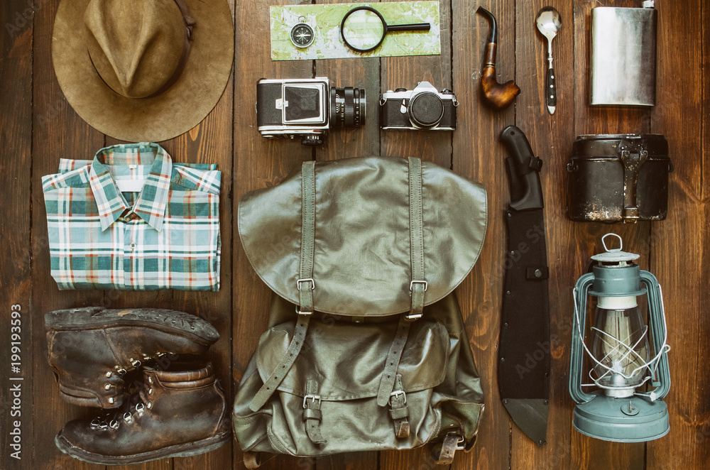 Jungle tropical forest, mountains hiking stuff arranged on wooden floor ...