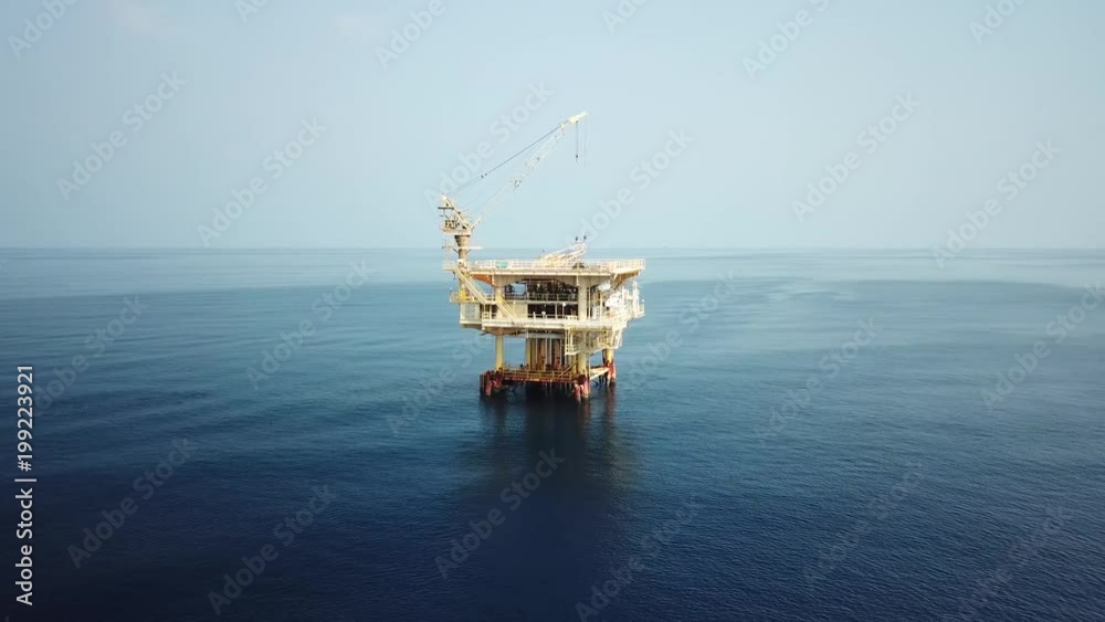 Aerial view from a drone of a small offshore platform in the middle of ...