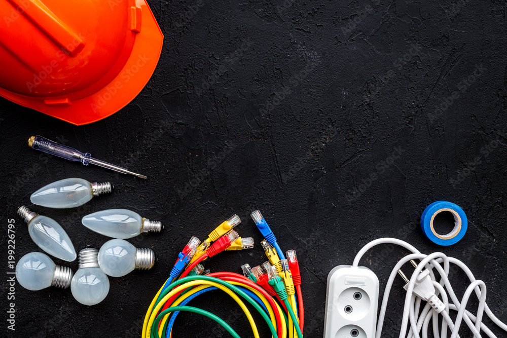 Electrician work concept. Hard hat, tools, cabel, bulb, socket outlet ...