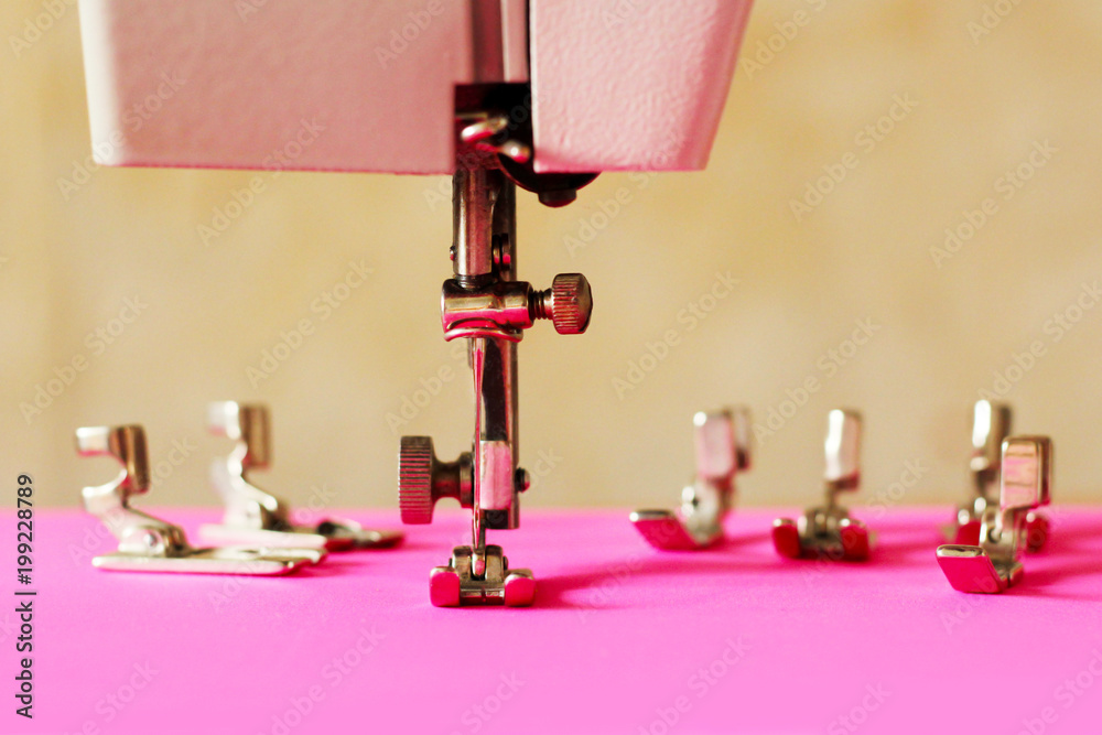 Group of sewing machine accessories. Various presser feet are used for ...